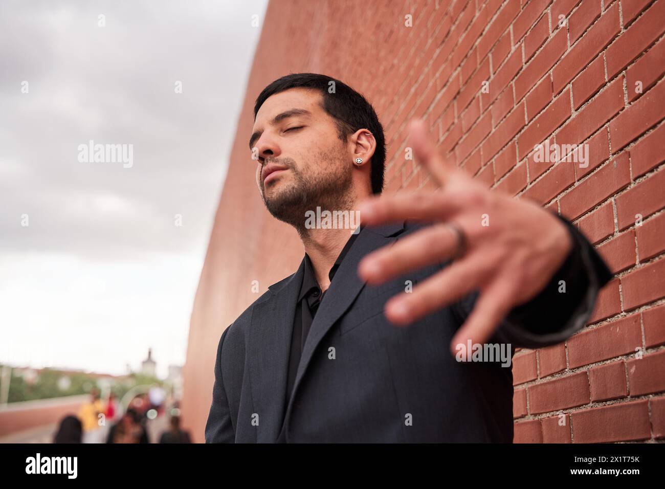 fashionable portrait of a latin man moving his hand in front of his ...