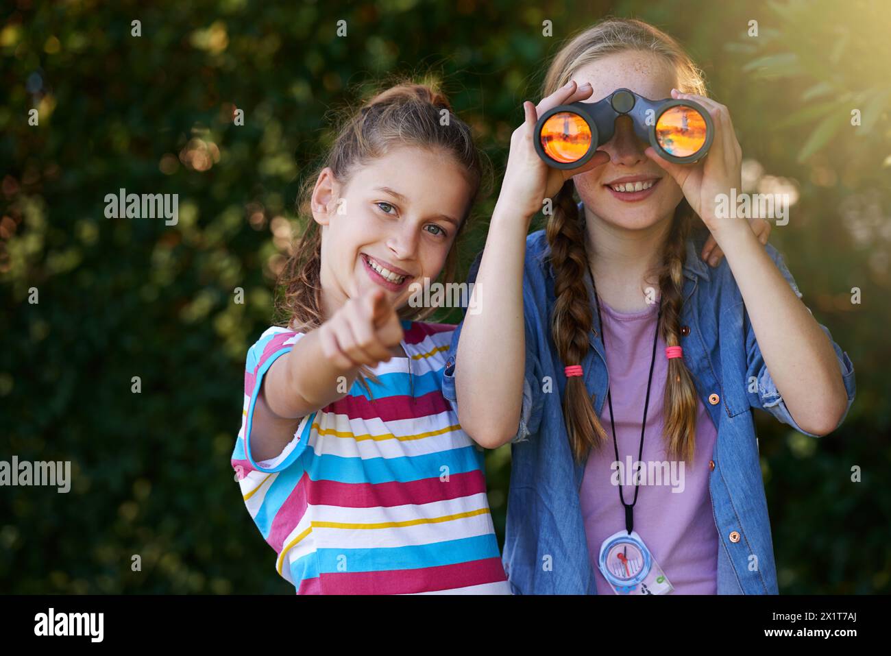 Portrait, kids and friends with binoculars, pointing and searching with ...