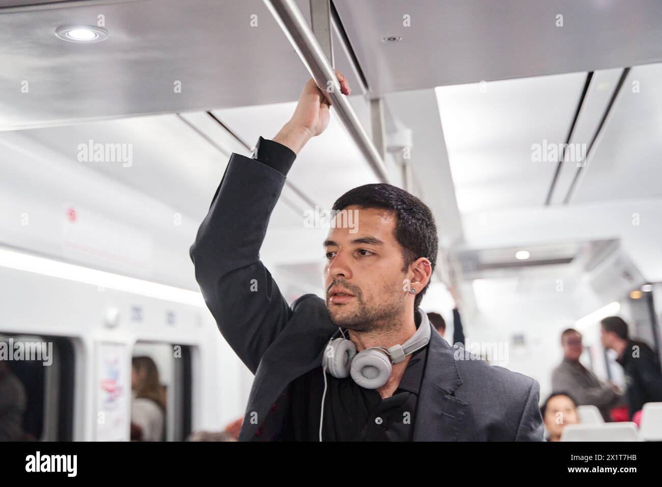 business man standing in the subway car. Man returning home after a day ...