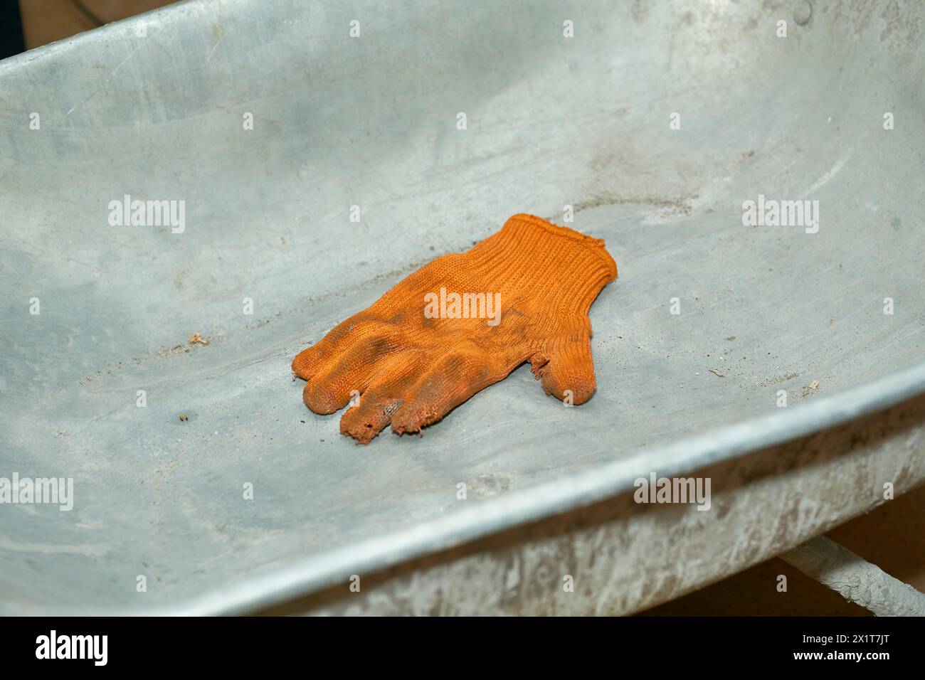 Old work rag glove in an iron construction wheelbarrow Stock Photo - Alamy