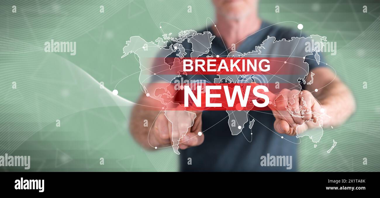 Man touching a breaking news concept on a touch screen with his fingers ...