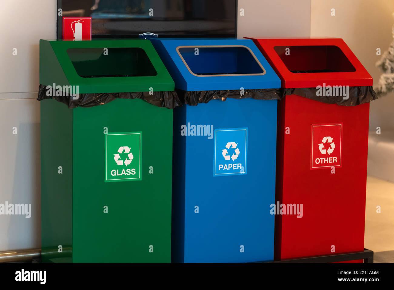 Close-up of green, blue, and red trash cans for separate dumping of ...