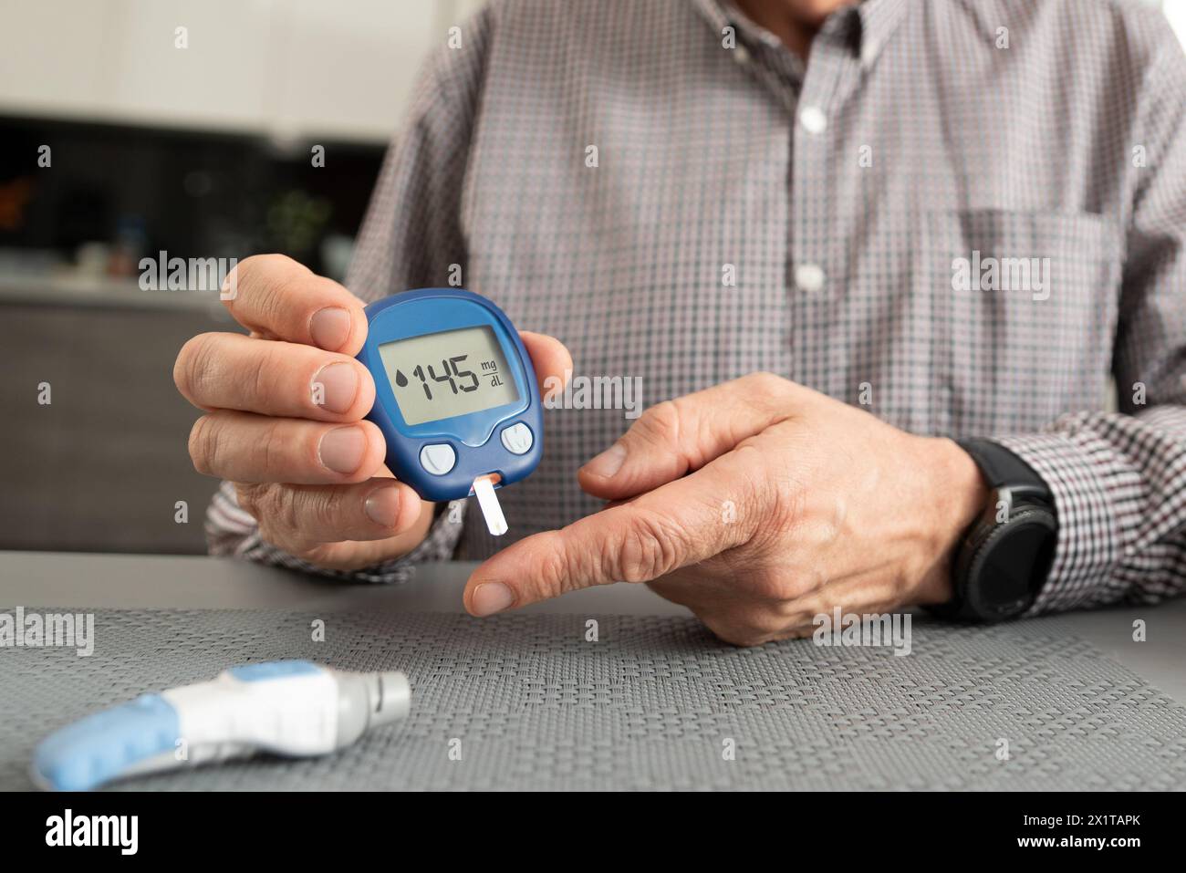 Man measures his blood sugar. Glucometer, blood sample test, diabetes ...