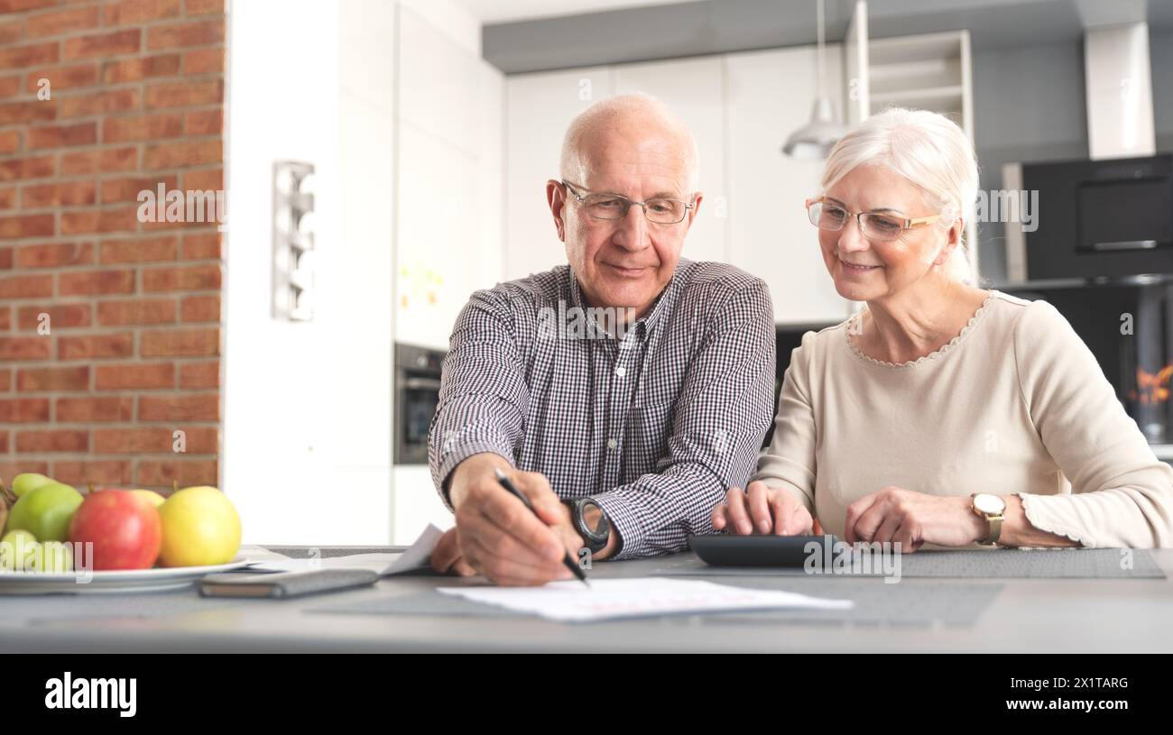 Senior couple checking their bills at home. Senior couple doing bill ...
