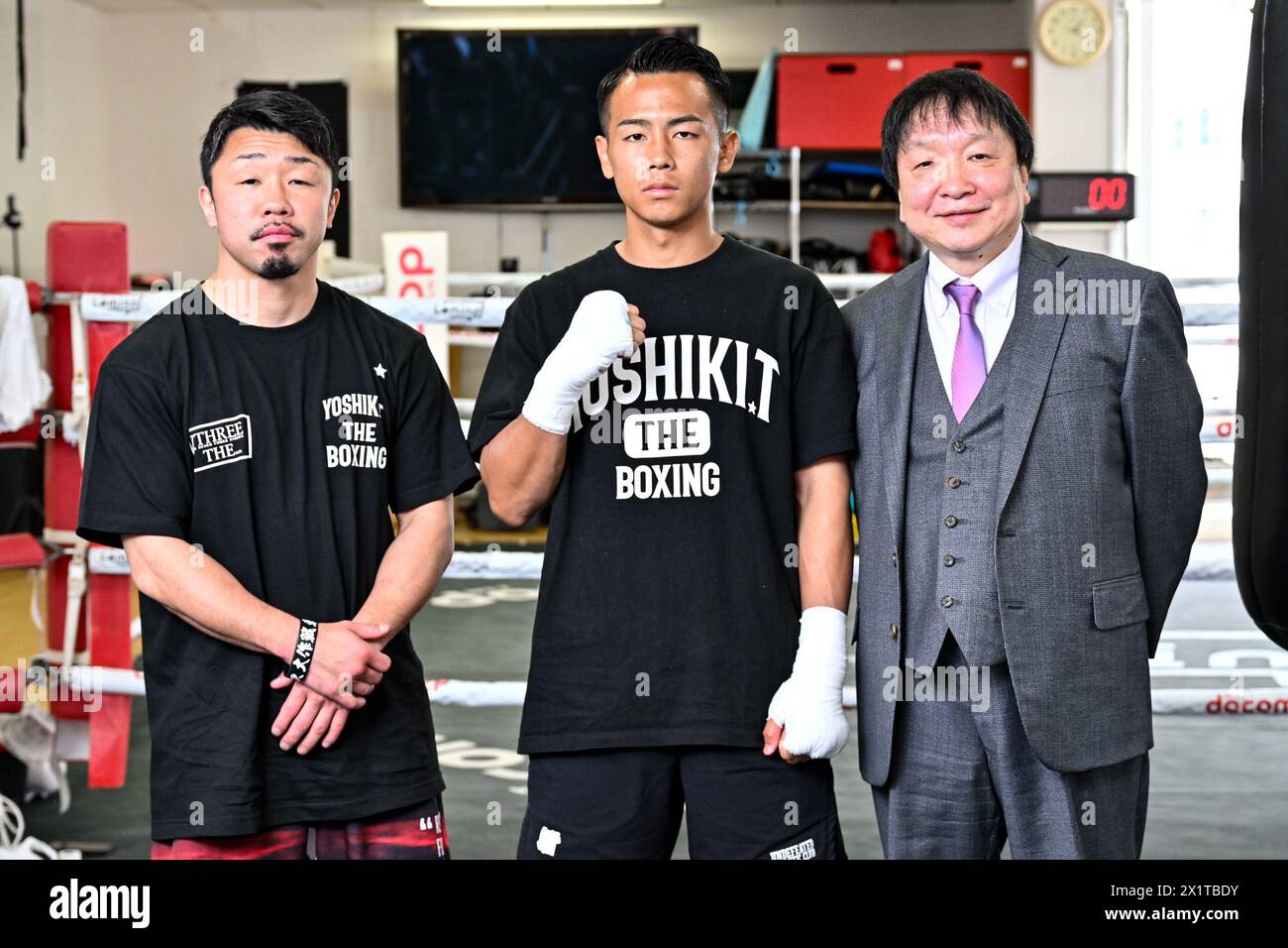 Yoshiki Takei (center), Japanese professional boxer, trainer Akira ...