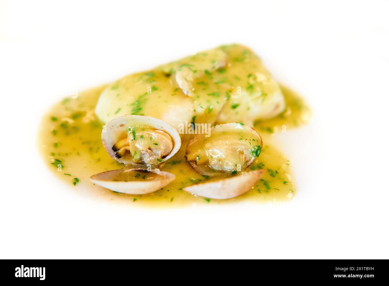 A delightful dish featuring juicy hake loin in a green sauce, enriched ...