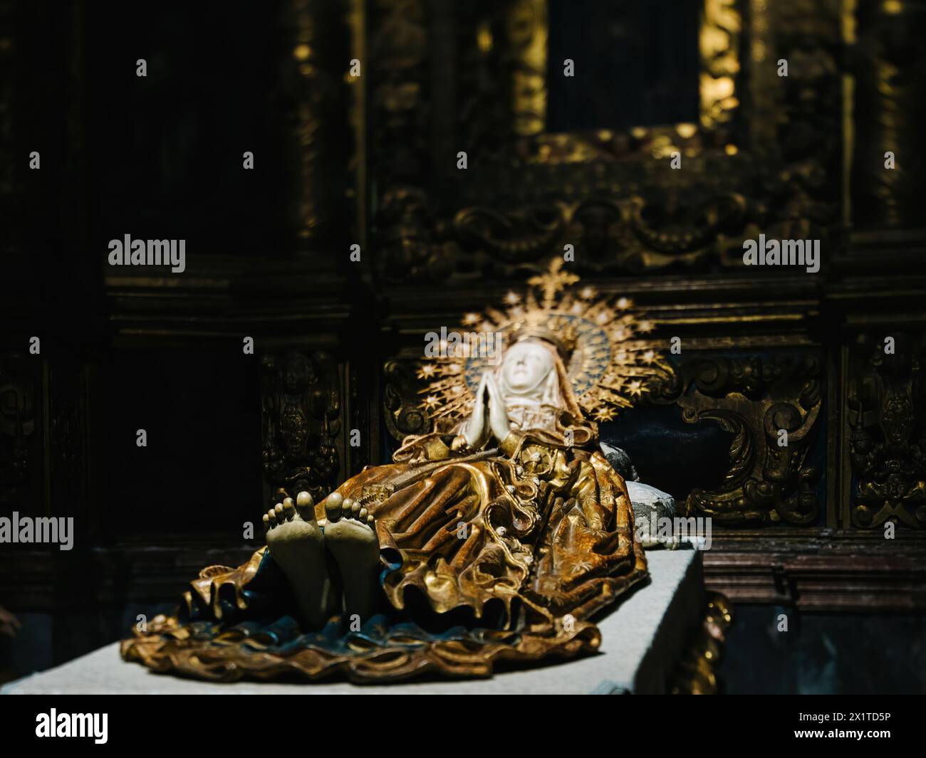 A close-up focus on the humble feet of the statue of Sleeping Mary in ...