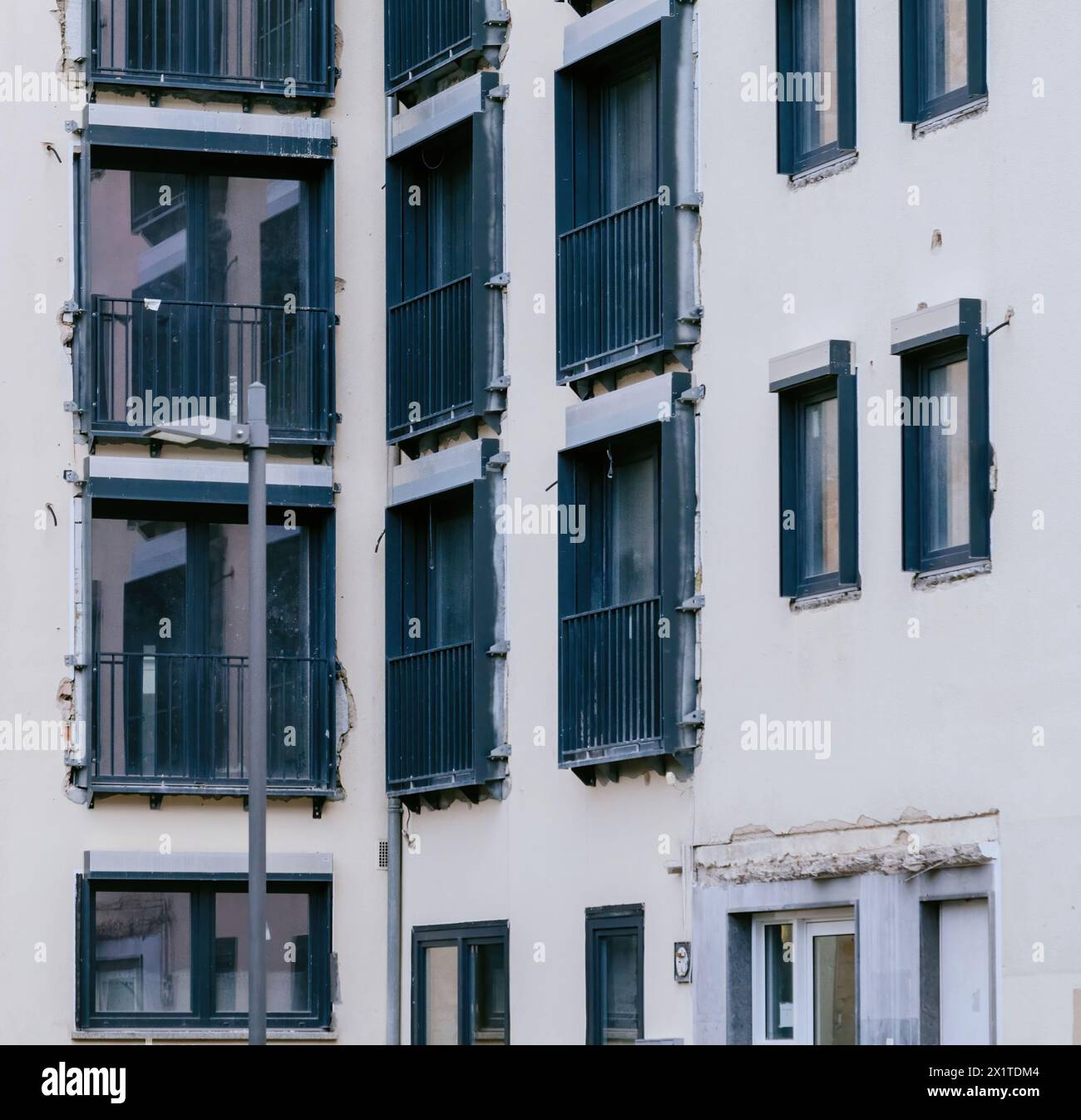 Apartment building house renovation featuring new window installations ...