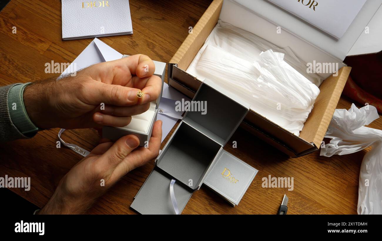 Paris, France - Sep 14, 2023: A man's hands elegantly present a Dior ...