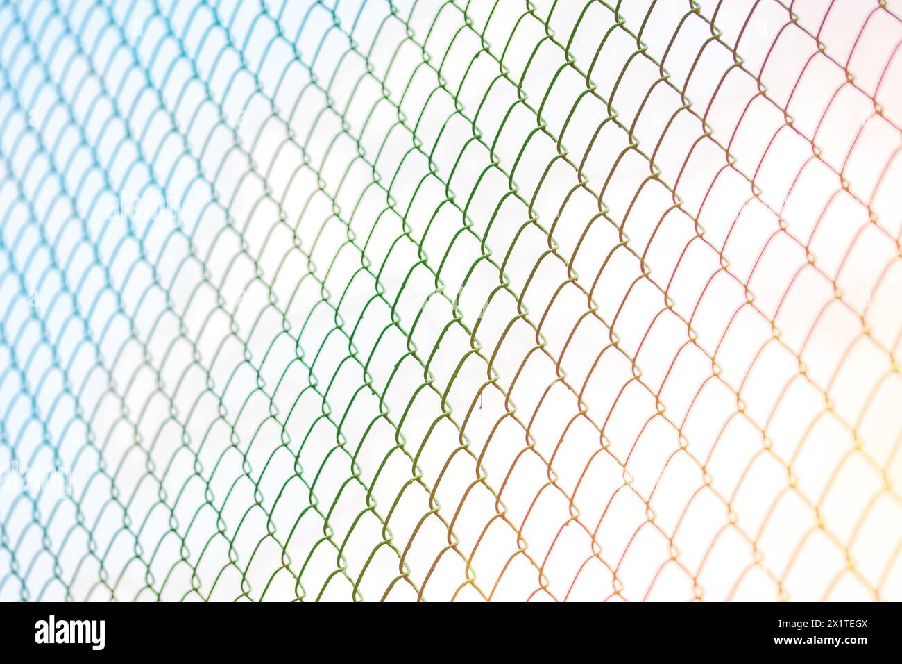 Mesh fence or metal grid at sunset. Steel grating fence made with wire ...