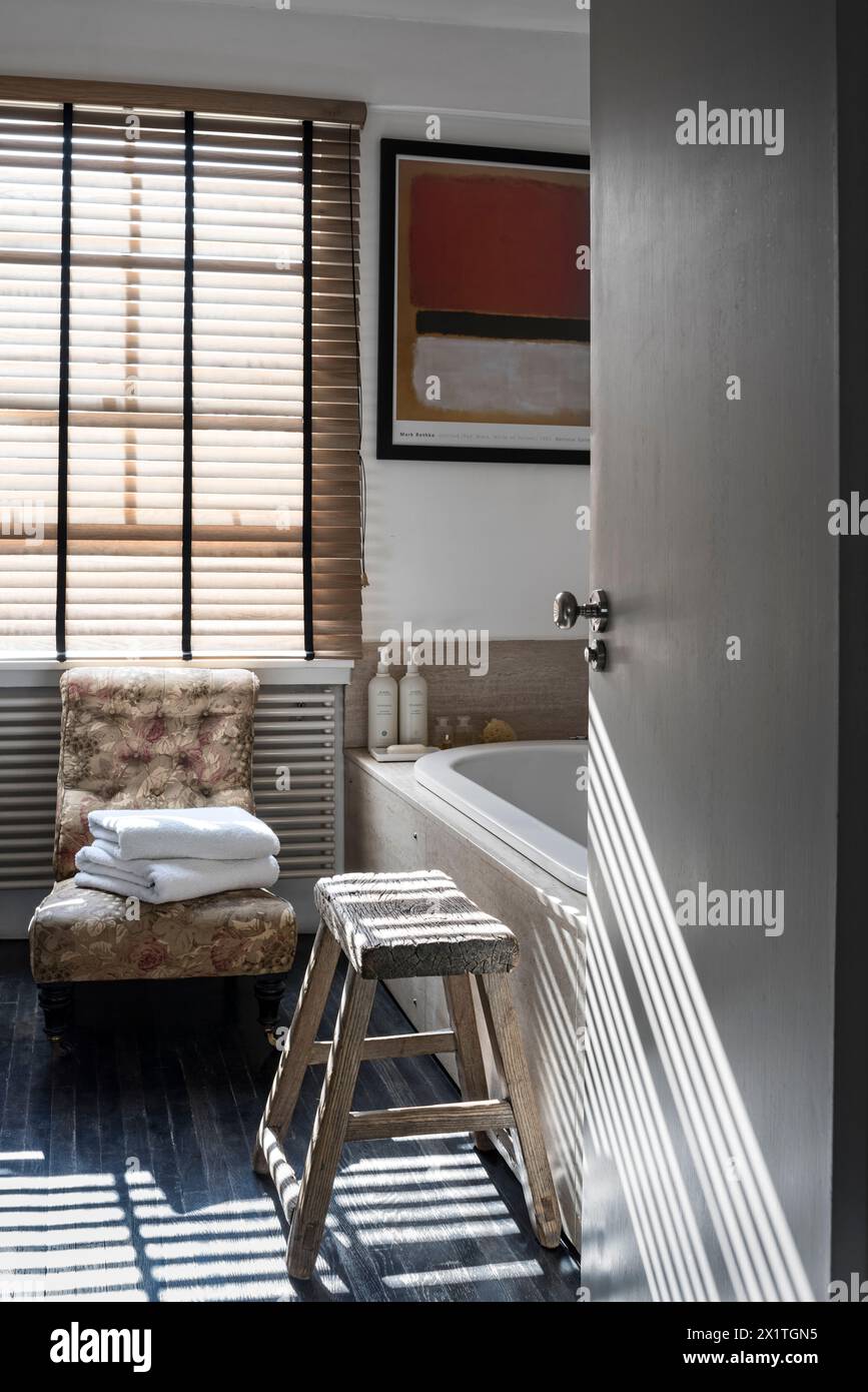 View through doorway to bathroom with sunlit Venetian blinds in Chelsea ...