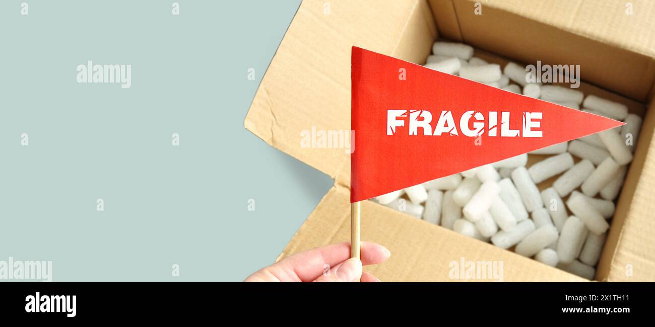 Opened cardboard packaging box with white polystyrene packing chips ...