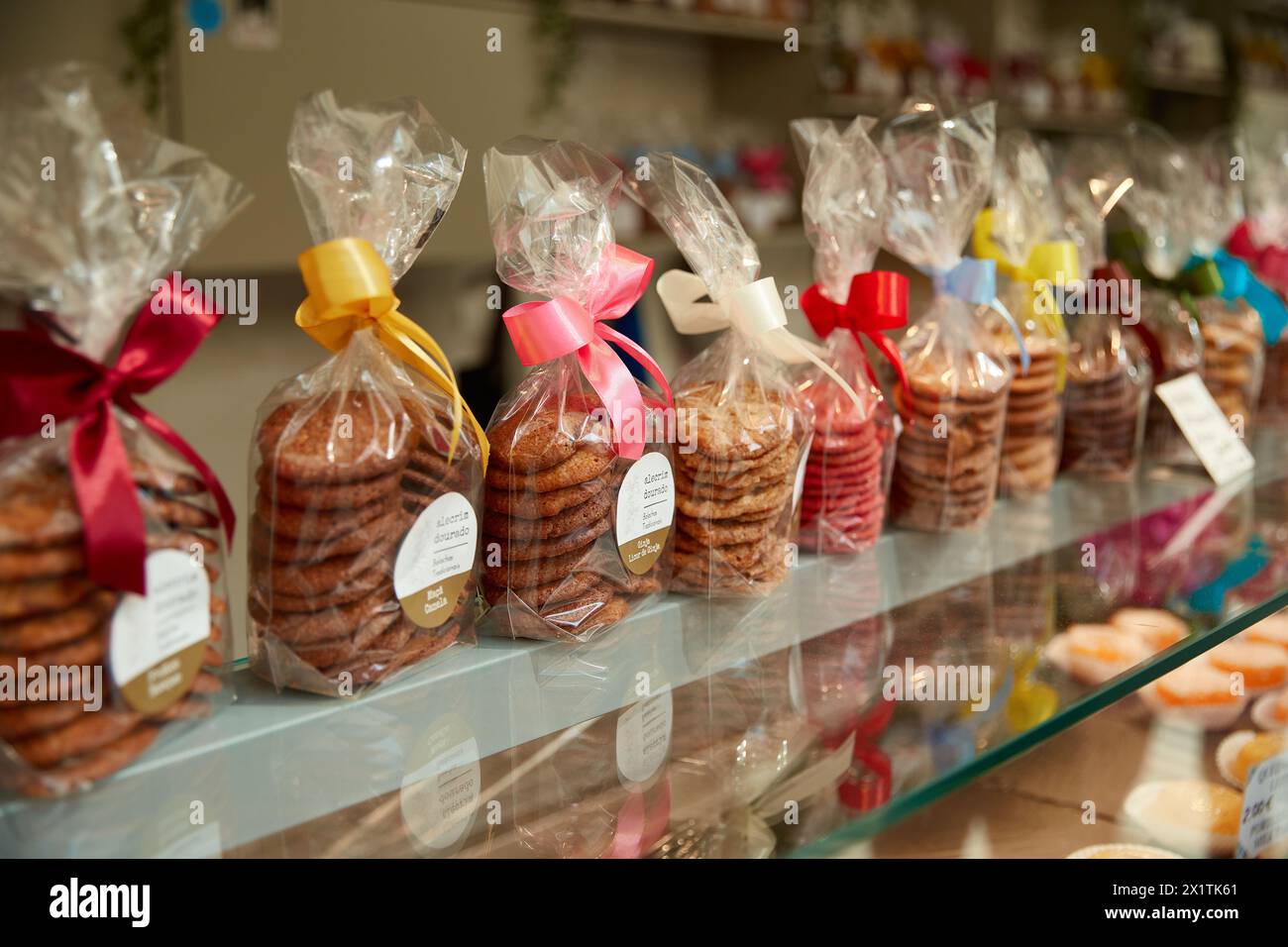 Packaged cookies with colorful ribbons on a bakery display shelf Stock ...