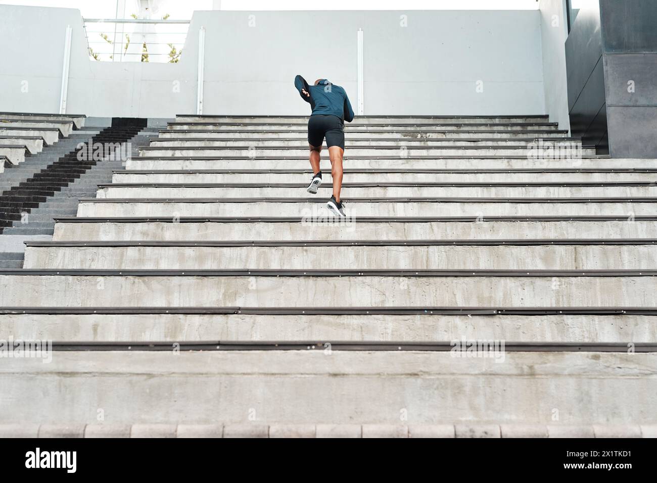 Running, steps and fitness man at stadium for energy, workout or ...