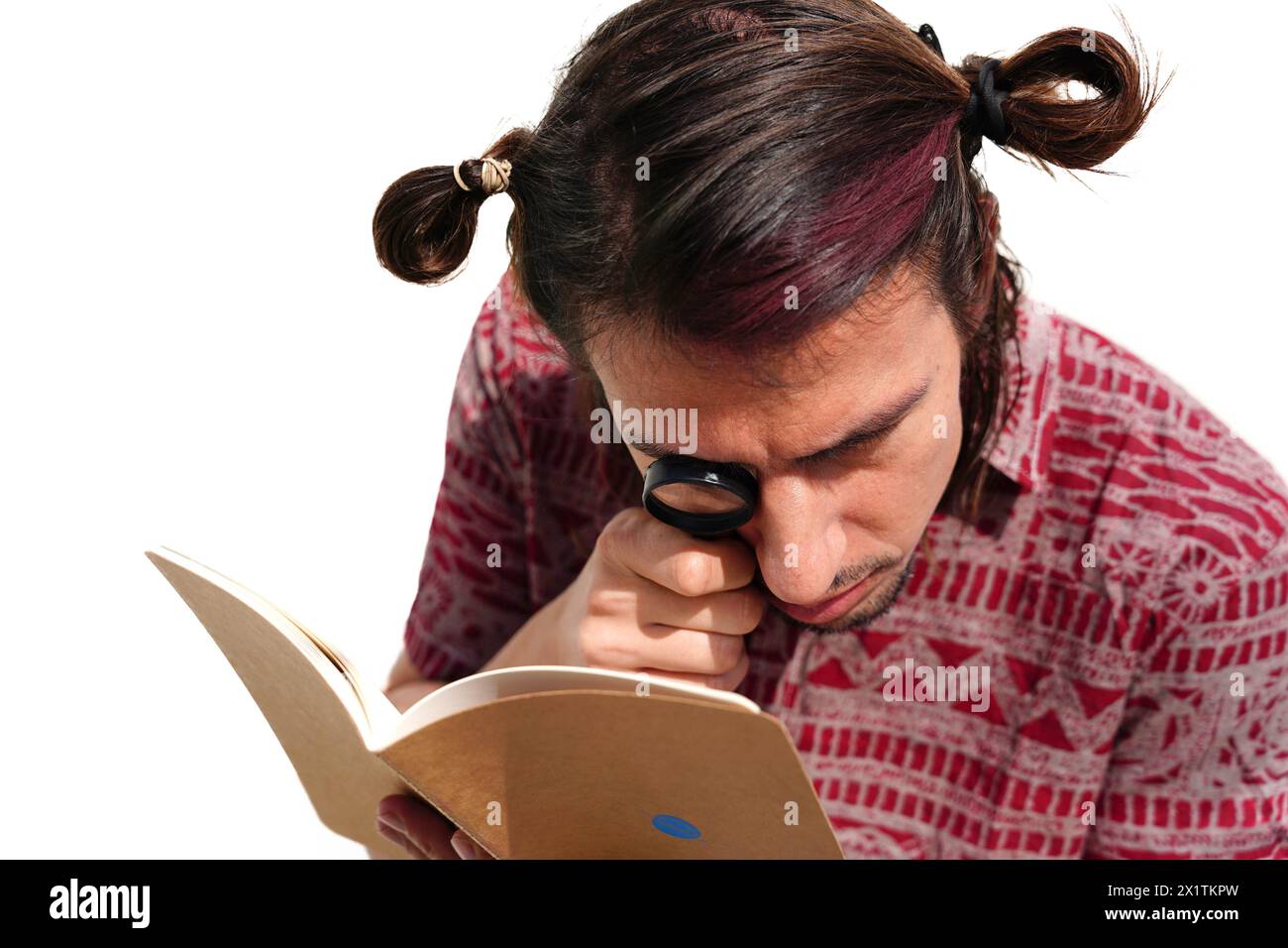 A funny hairstyle man with myopia is looking at a book with a ...