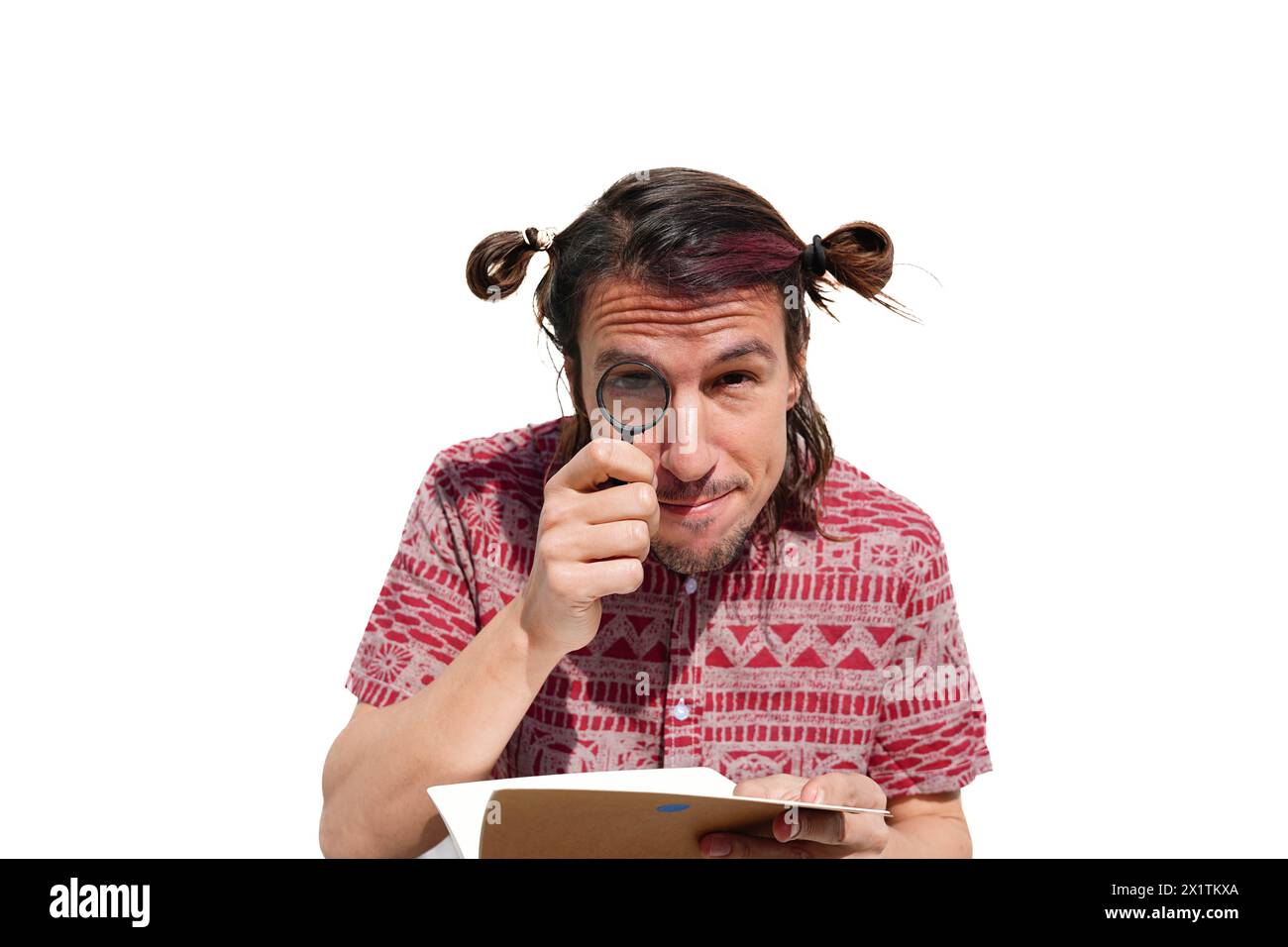 A detective with a magnifying glass in his hand looking a notebook with ...