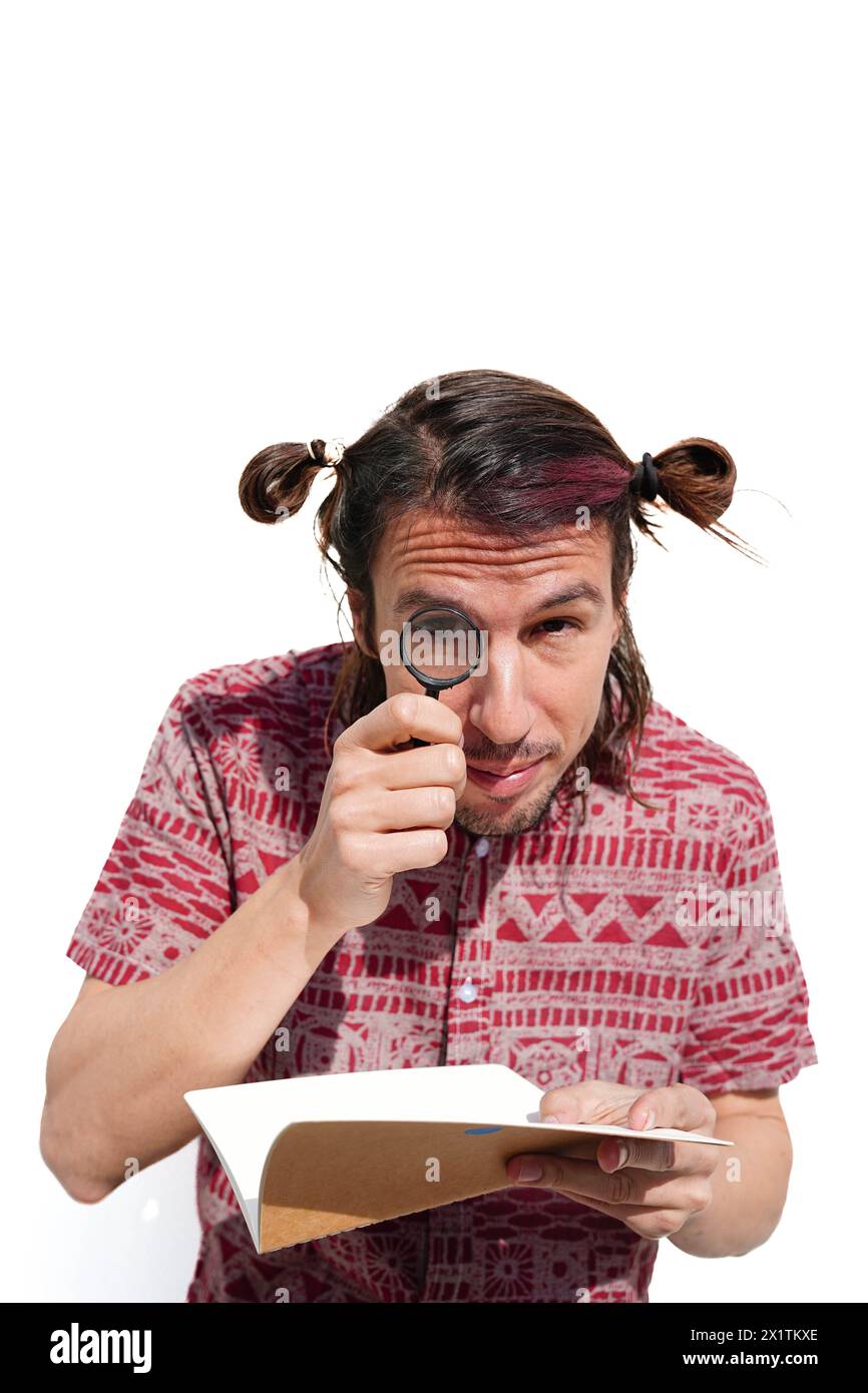 A curious man with a magnifying glass is looking at a book for ...