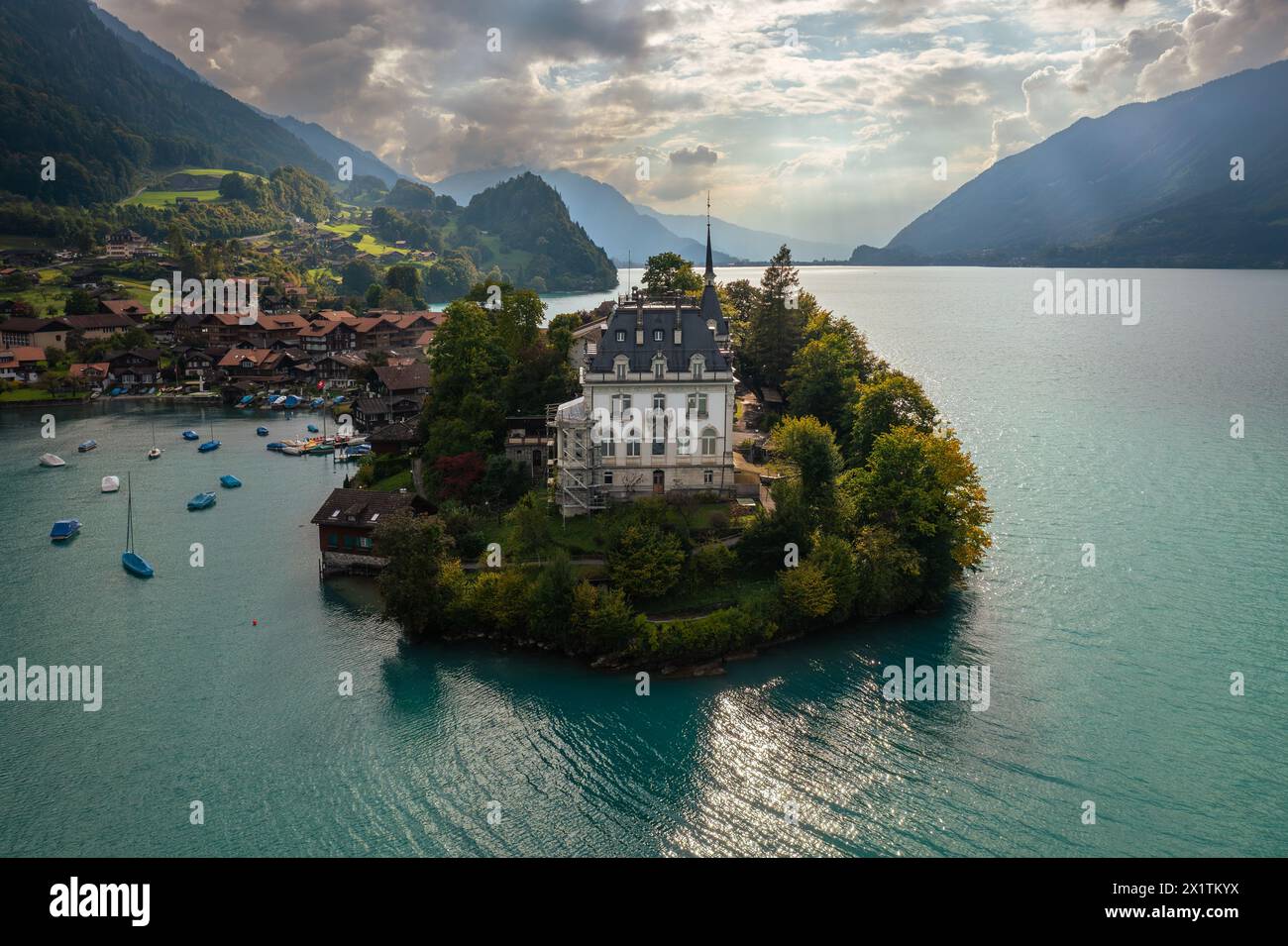 Iseltwald village on a peninsula in lake Brienz on a dramatic cloudy ...