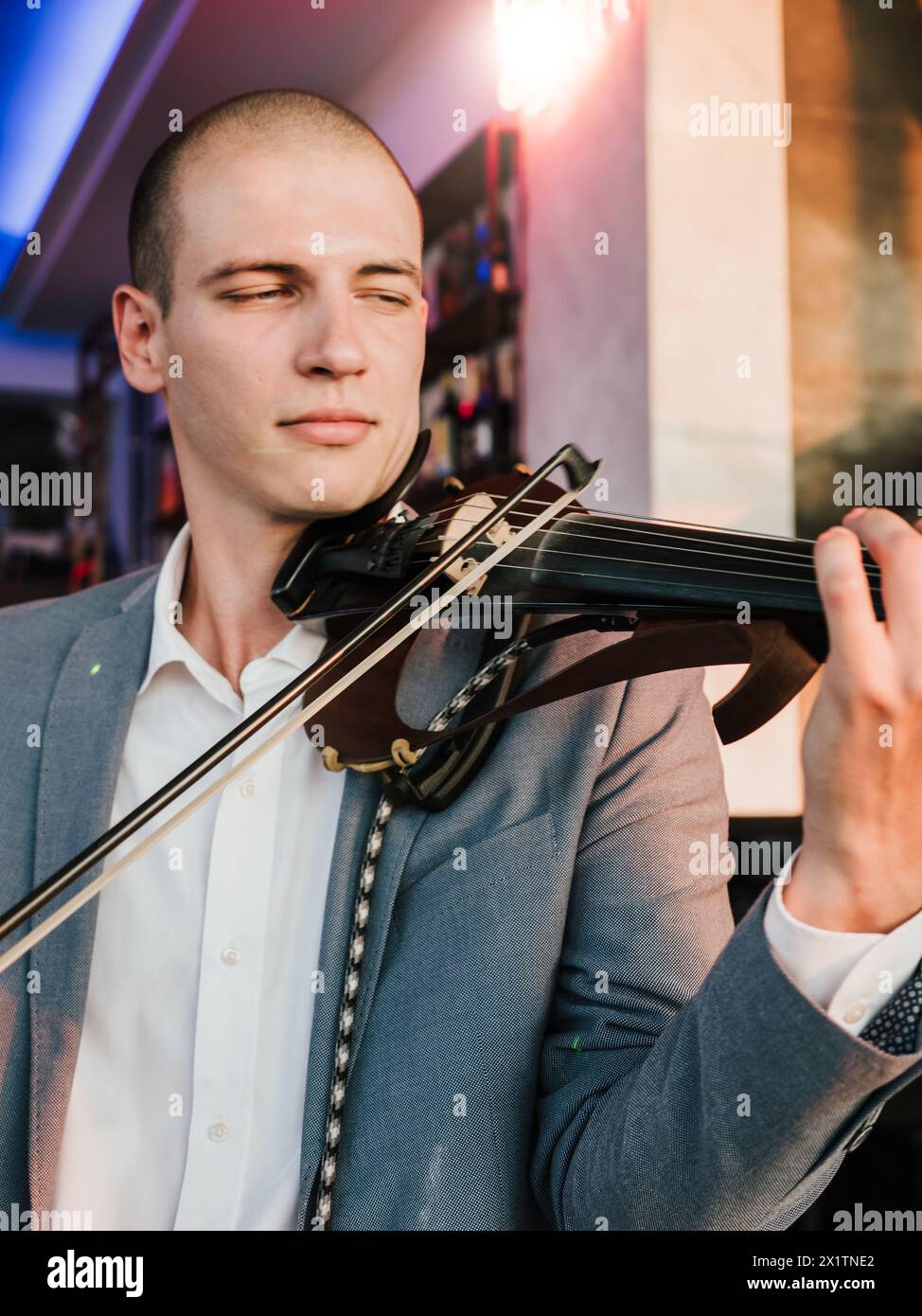Musician with electric violin, lost in moment Stock Photo - Alamy