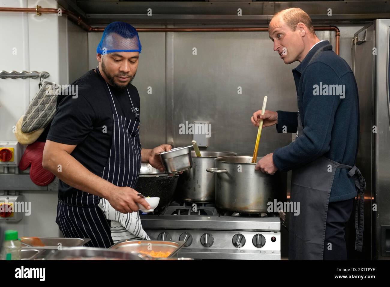The Prince of Wales (right) helps make bolognase sauce with head chef ...