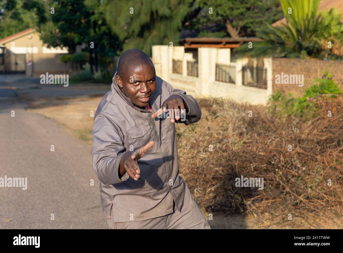 happy african worker with a smile fooling around, outdoors in a sunny ...