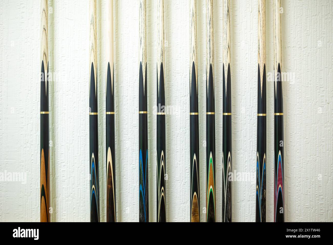 Hand made snooker cues lined up ion a showroom Stock Photo - Alamy