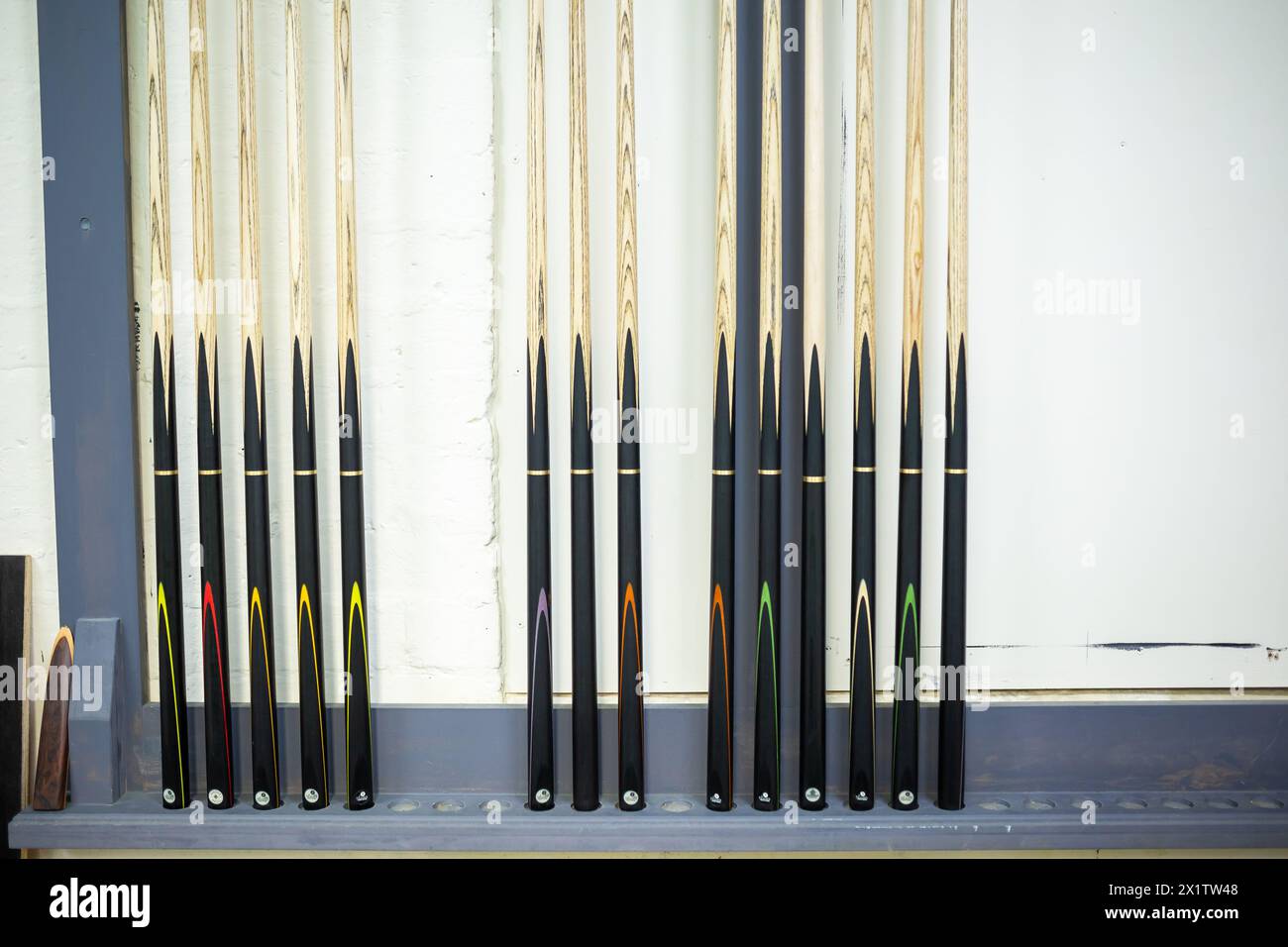 Hand made snooker cues lined up ion a showroom Stock Photo - Alamy