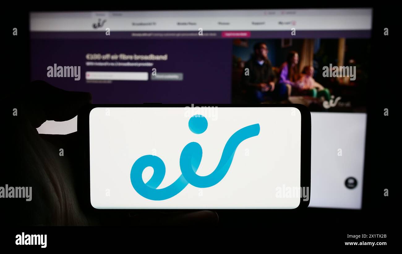 Person holding cellphone with logo of Irish telecommunications company ...