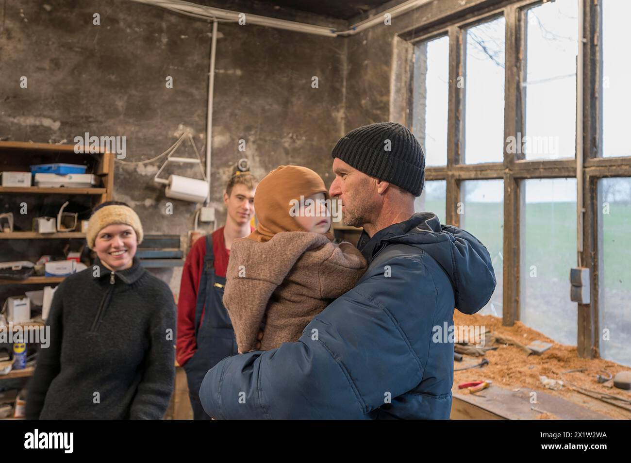 Family reunion in the workshop, father, daughter, son and grandson ...