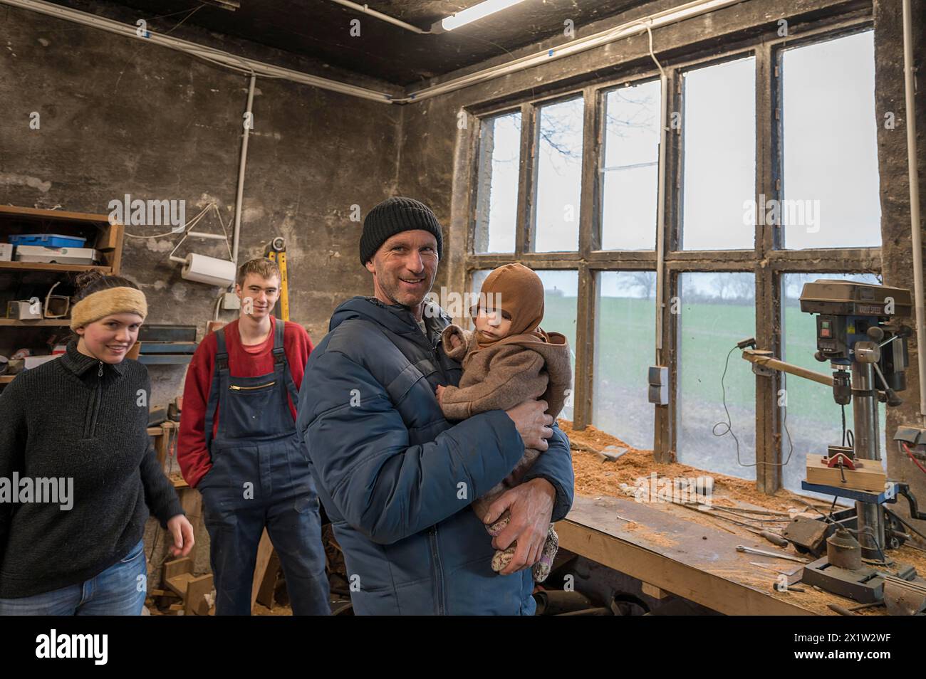 Family reunion in the workshop, father, daughter, son and grandson ...