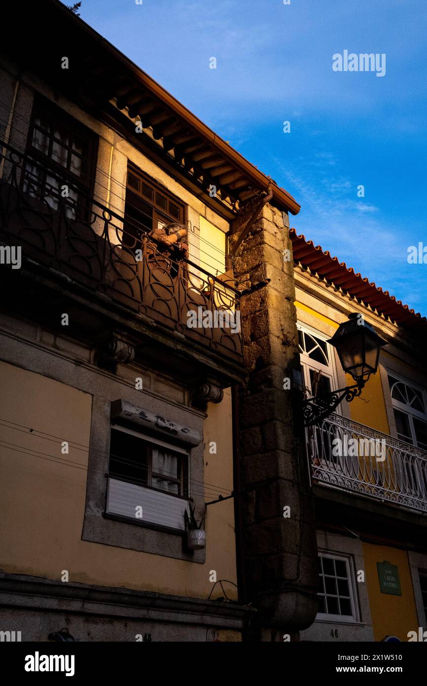 A colourful historic yellow building typical of the city of Porto in ...