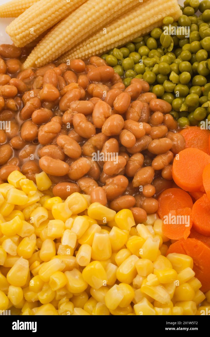 Close-up of mixed cooked vegetables that include brown baked beans ...