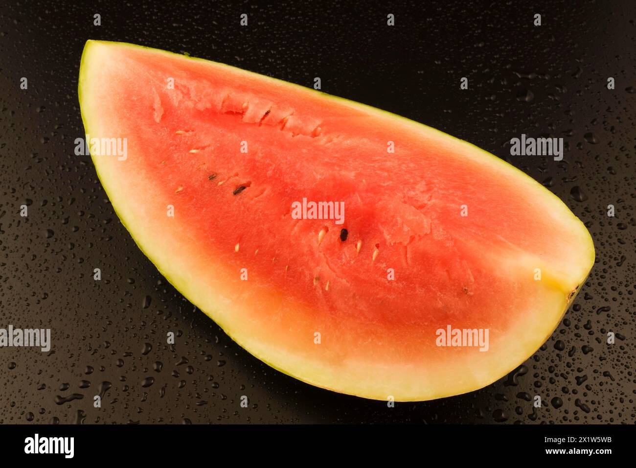 Top view and close-up of half a Citrullus lanatus, Watermelon on black ...