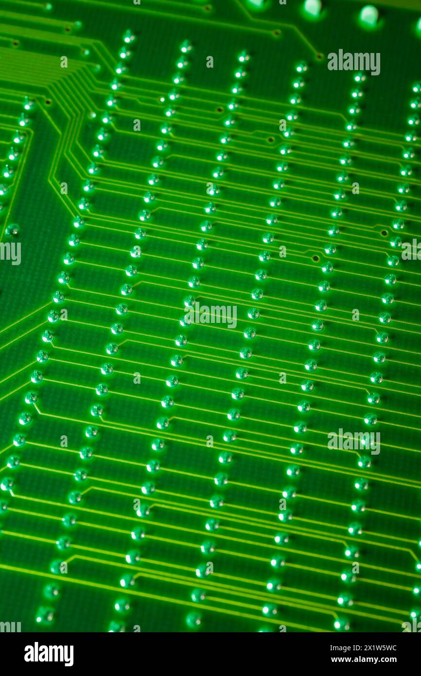 Close-up of fluorescent green lighted electronic computer circuit board ...