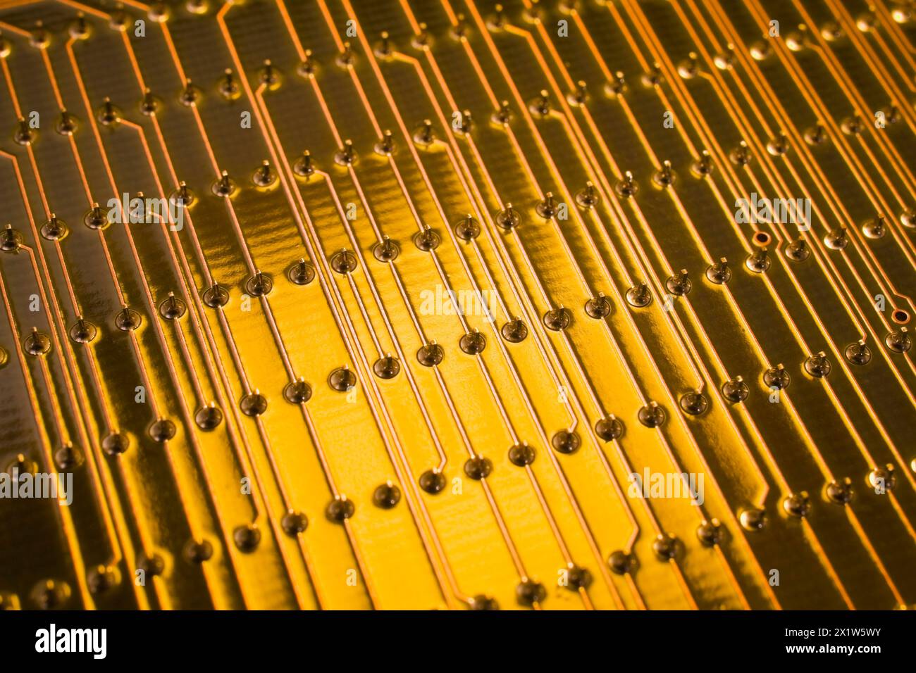 Close-up of golden yellow lighted electronic computer circuit board ...