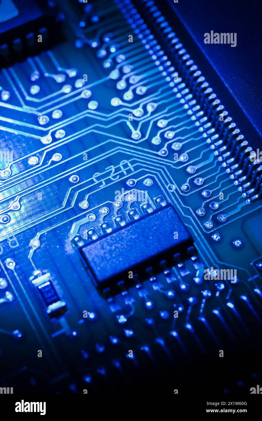 Close-up of blue lighted electronic computer circuit board with ...