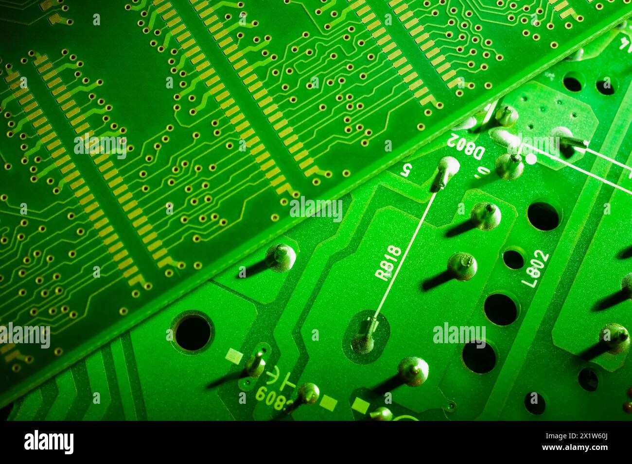 Close-up of fluorescent green lighted electronic computer circuit boards with silver solder ...