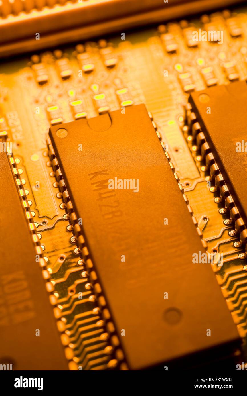 Close-up of orange yellow lighted electronic computer circuit board ...