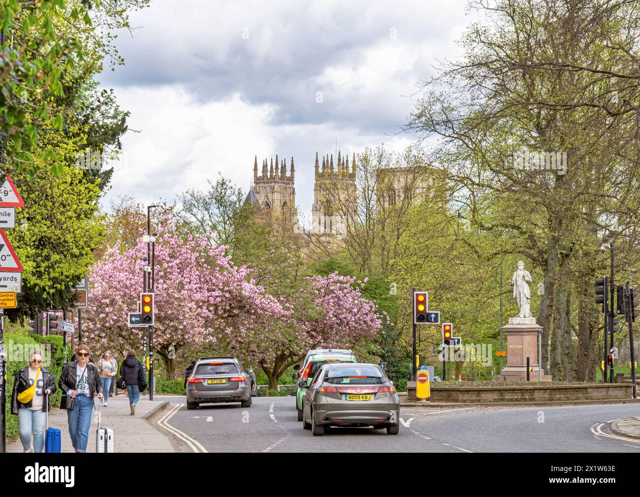 A road junction with a bus at traffic lights. The towers of York ...