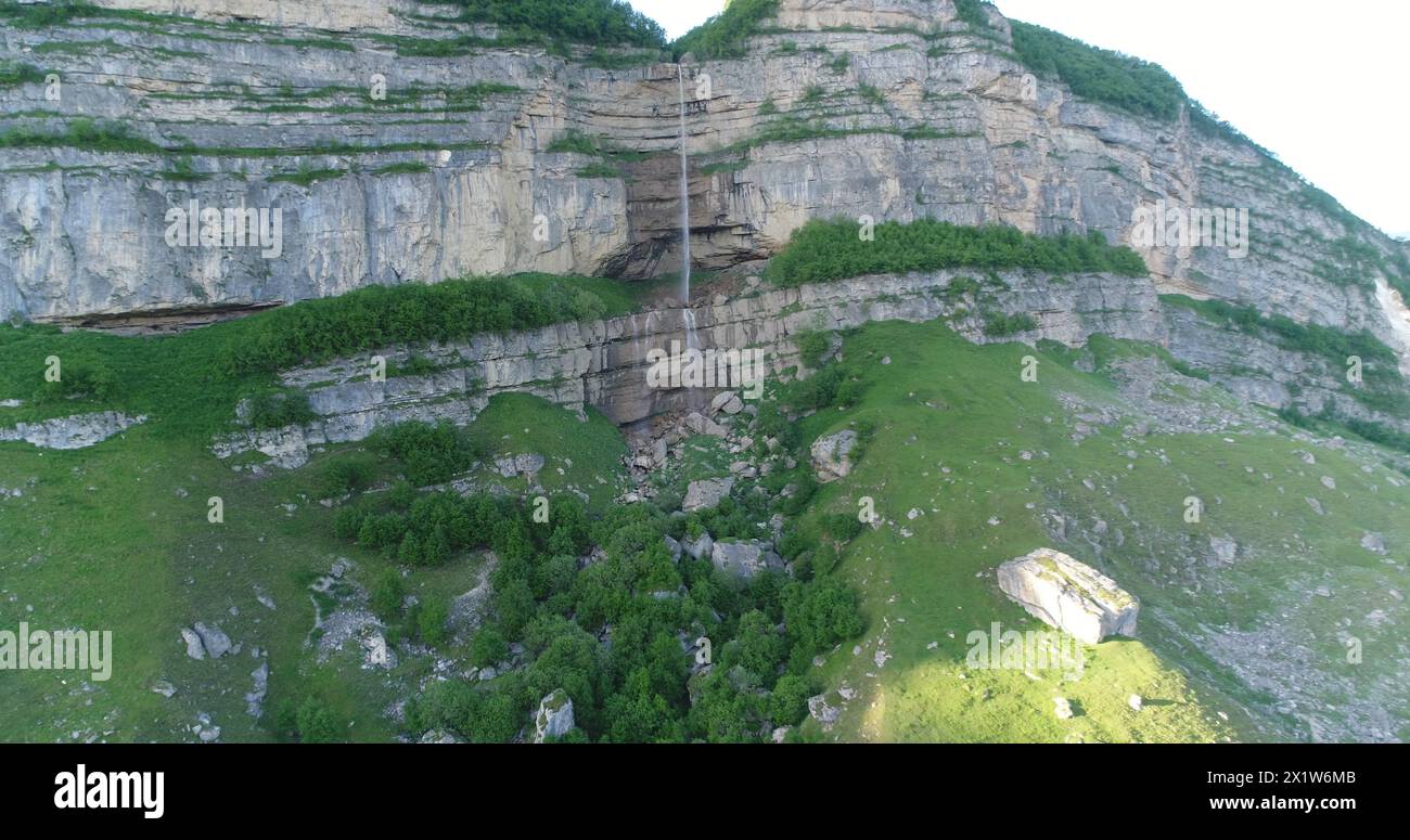 Aerial view of a cliff in the mountains with a waterfall Stock Photo ...