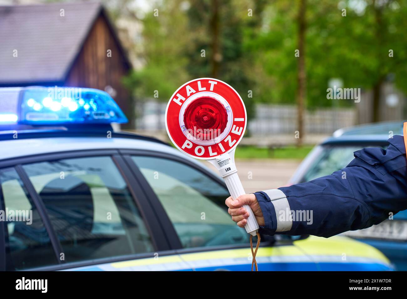 Augsburg, Bavaria, Germany - April 17, 2024: Police officer holds a ...