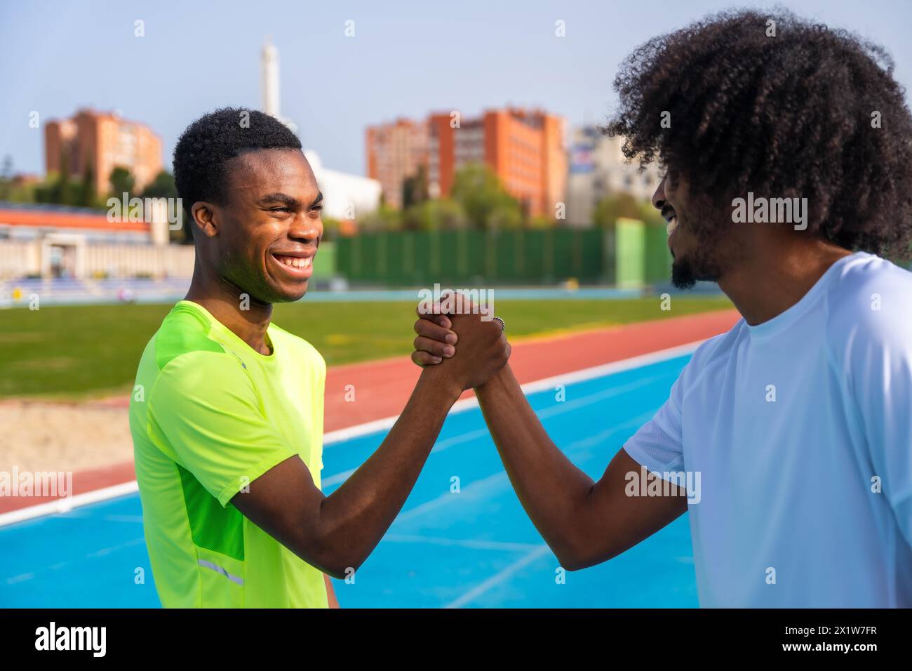 African american runner friends shaking hands while working out ...