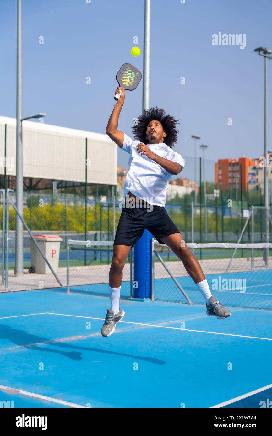 Vertical full length photo of a african american young sportive man ...
