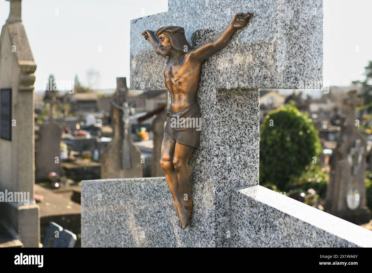 Crucified Jesus Christ on a cross on a grave in a cemetery Stock Photo - Alamy