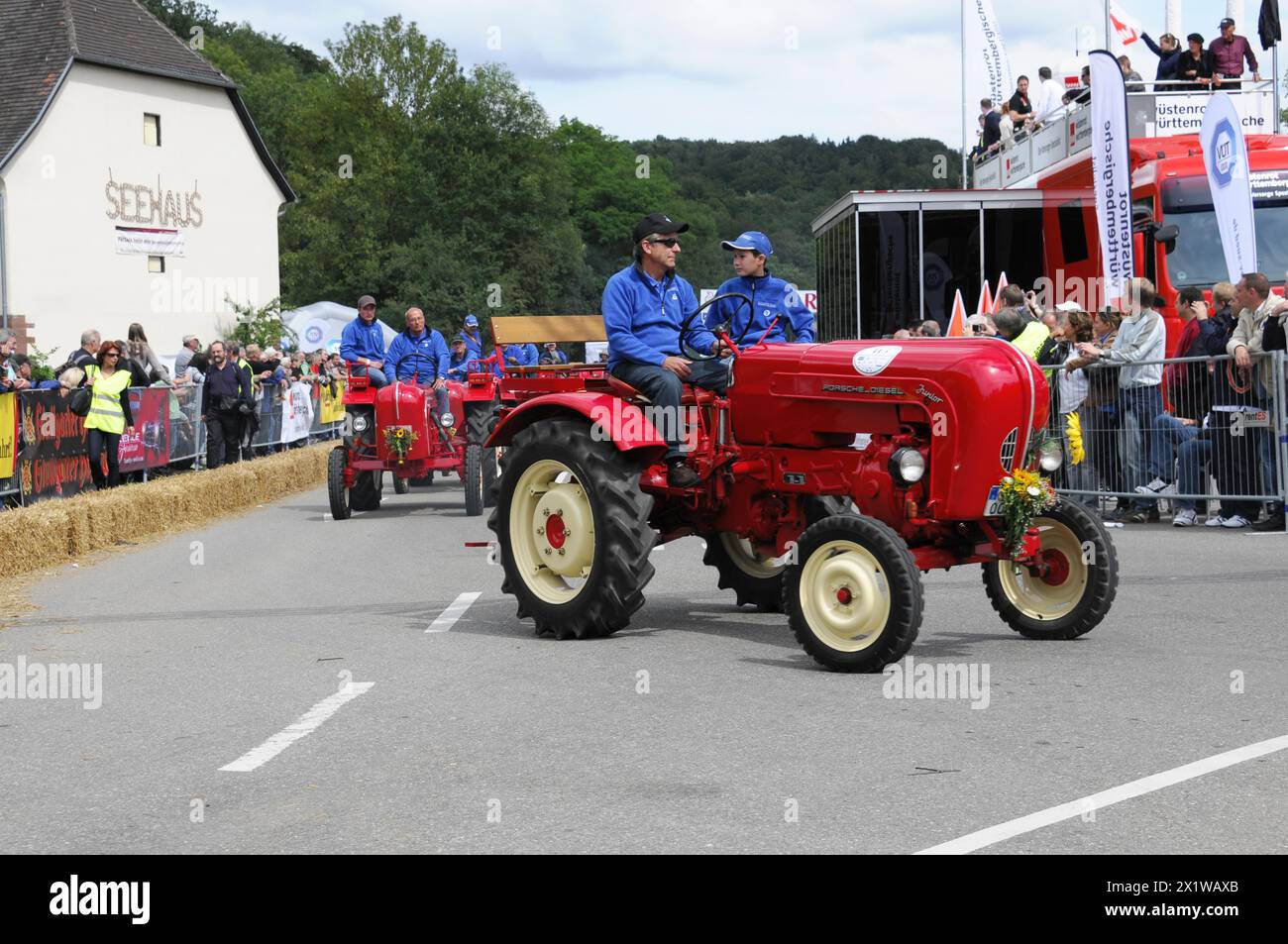 Porsche diesel tractors, drivers in blue present their red vintage ...