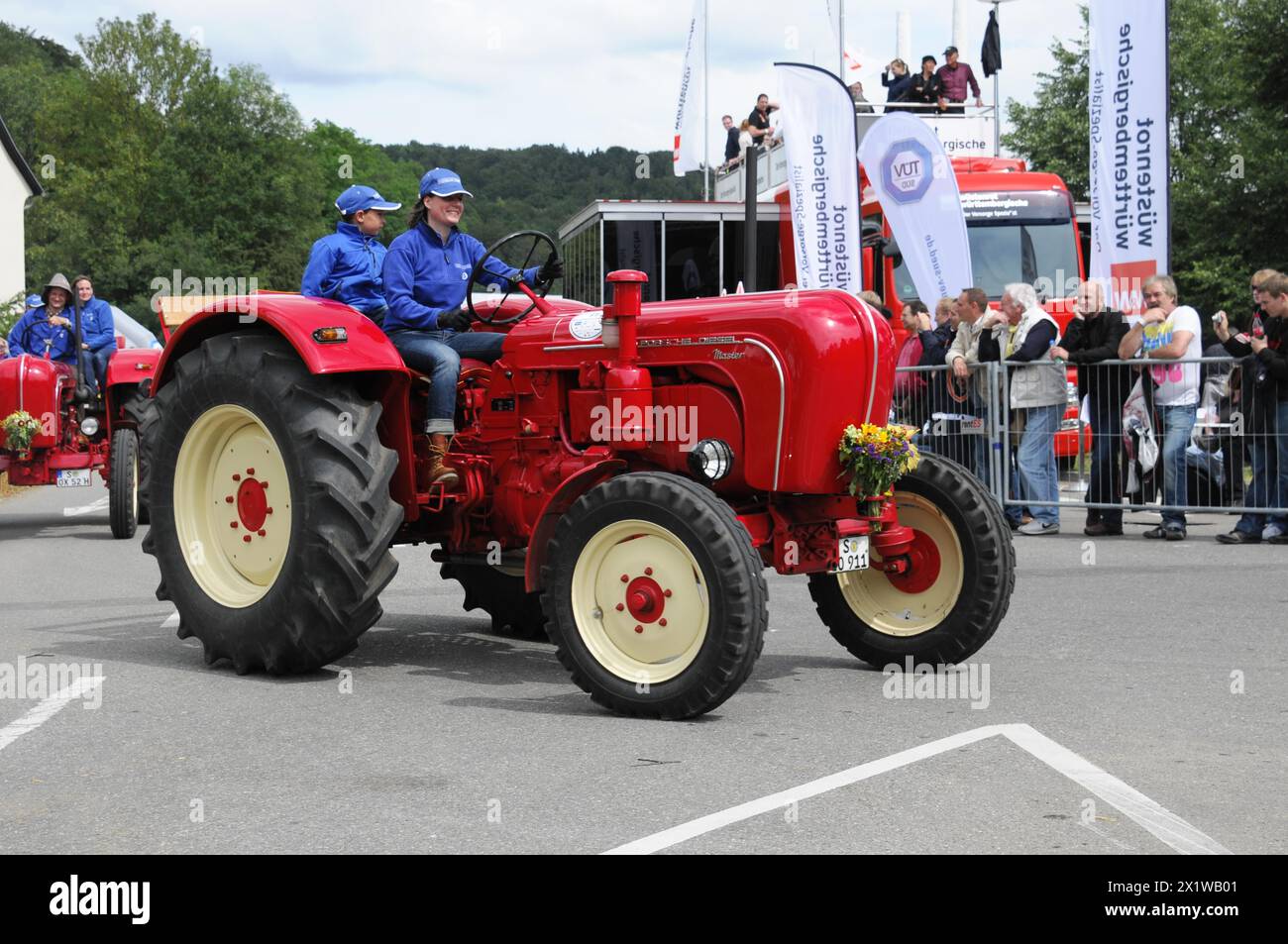 Porsche Diesel Tractors, A red vintage tractor is presented at an event ...