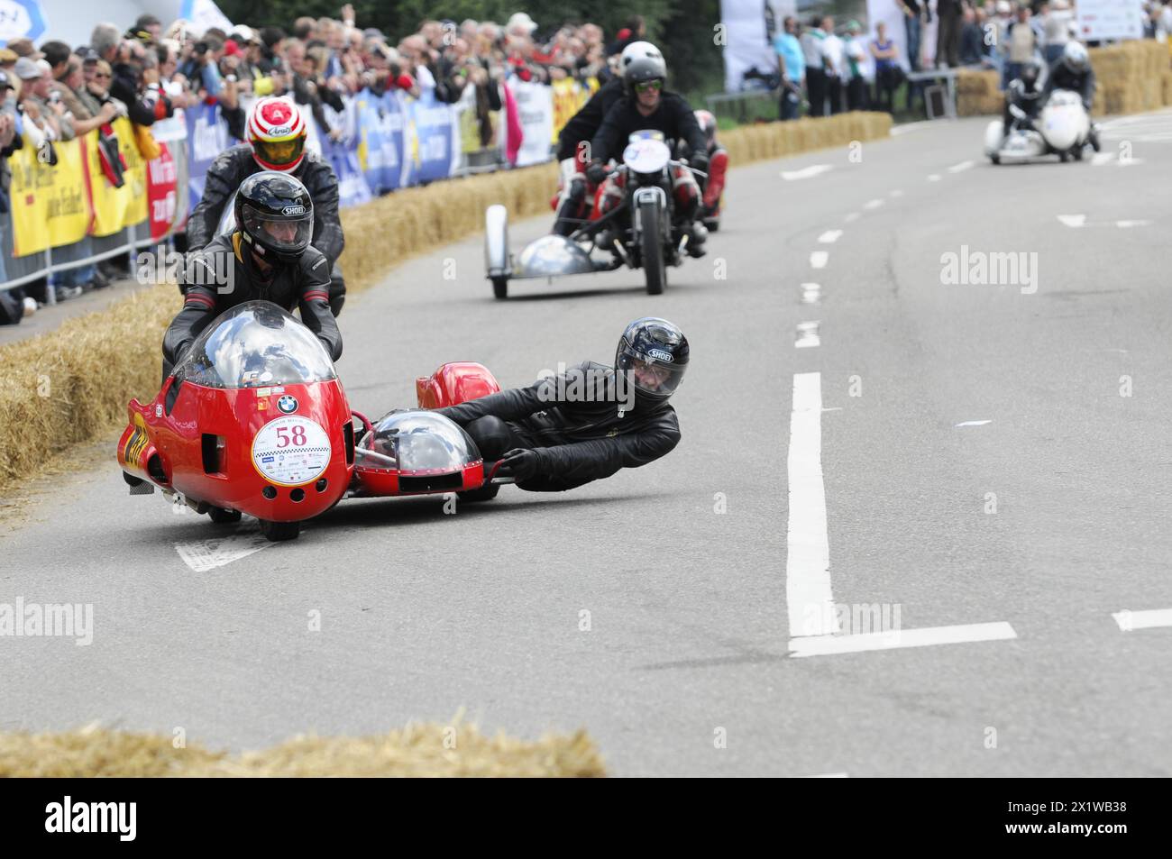 A red sidecar motorbike in a race, teamwork of rider and passenger ...