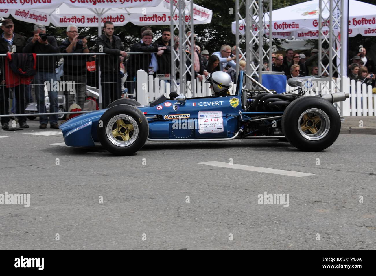 Blue formula racing car at the starting position of a race, driver with ...