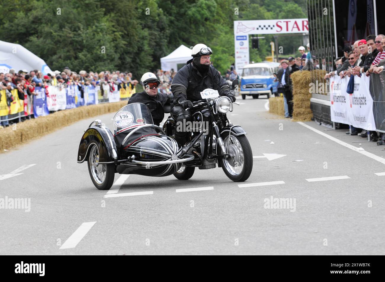 Motorbike with sidecar and riders in leather clothing at a classic car ...
