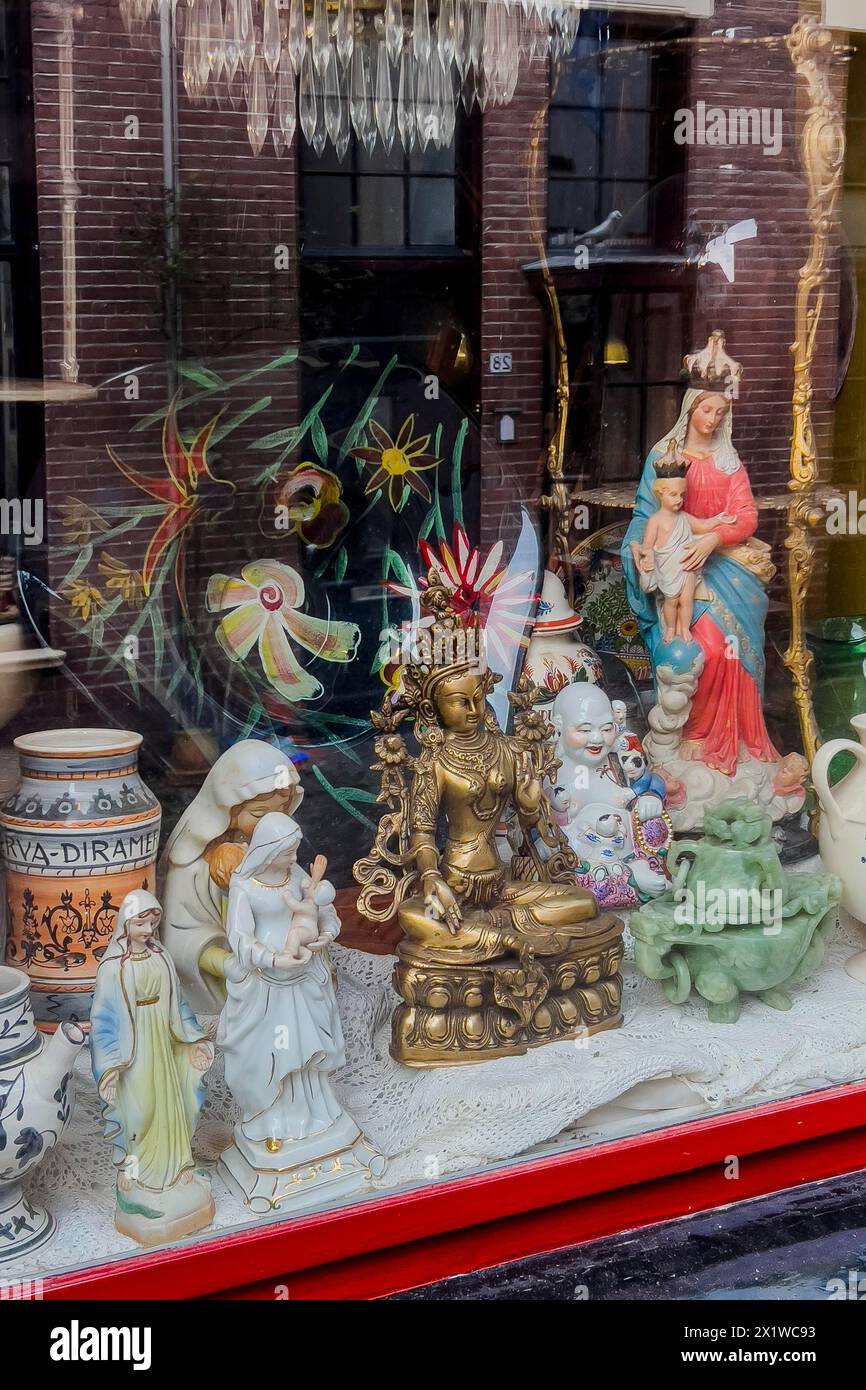 Display window with various religious sculptures, religion ...